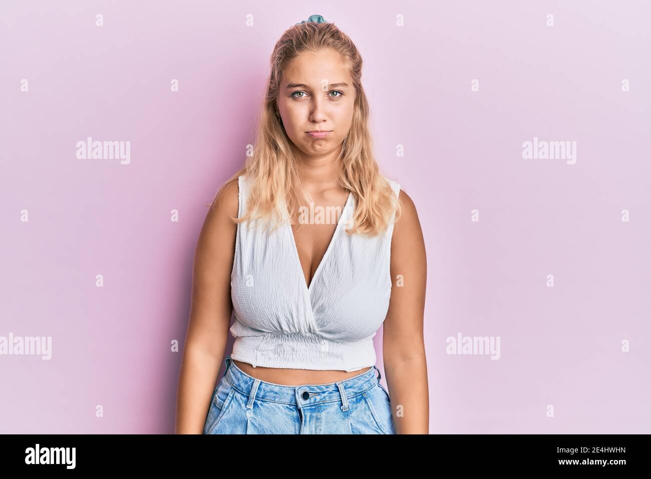 Young blonde girl wearing casual clothes depressed and worry for ...