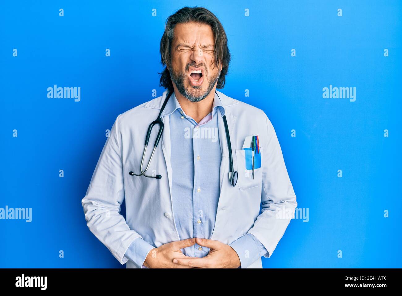 Middle age handsome man wearing doctor uniform and stethoscope with ...