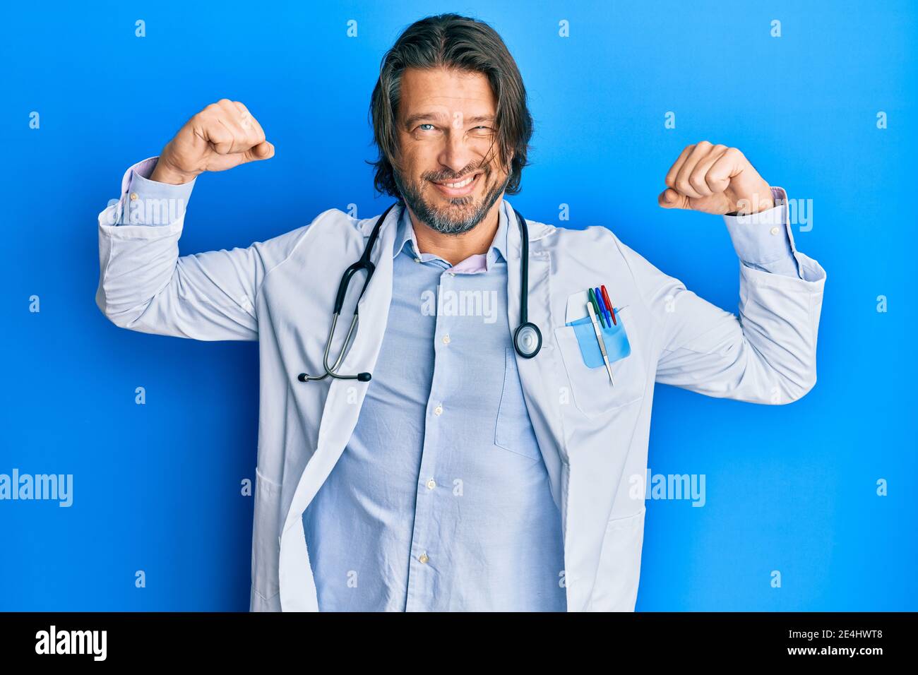 Middle age handsome man wearing doctor uniform and stethoscope showing ...