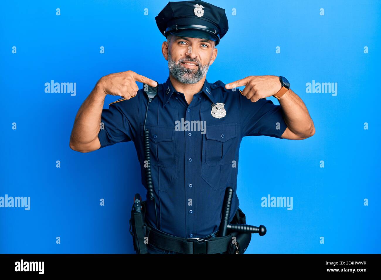 Middle age handsome man wearing police uniform looking confident with ...