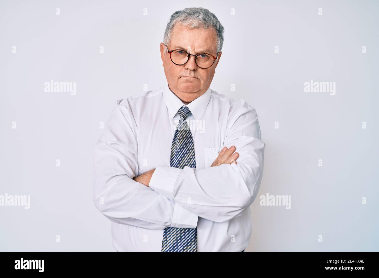 Senior grey-haired man wearing business clothes skeptic and nervous ...