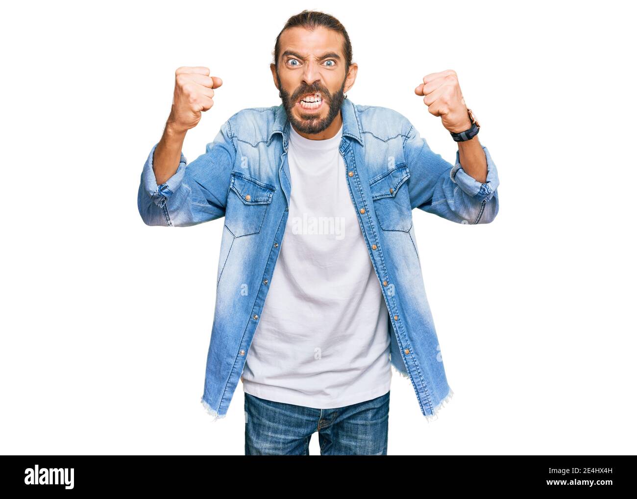 Attractive man with long hair and beard wearing casual denim jacket ...