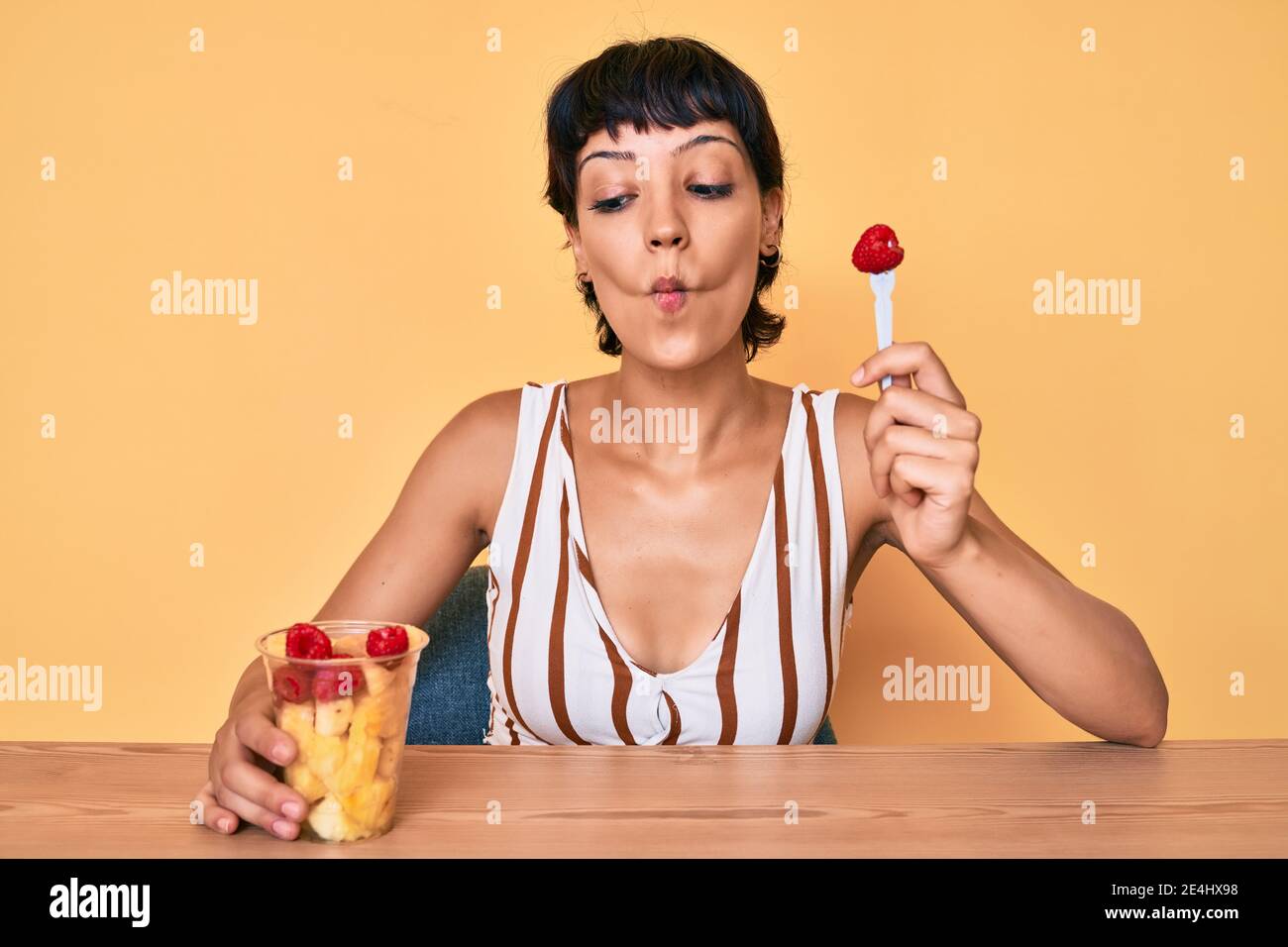 Woman and comical expression and eating hi-res stock photography and ...