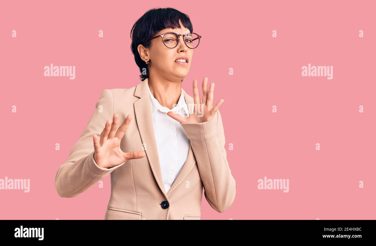 Young brunette woman with short hair wearing business jacket and ...