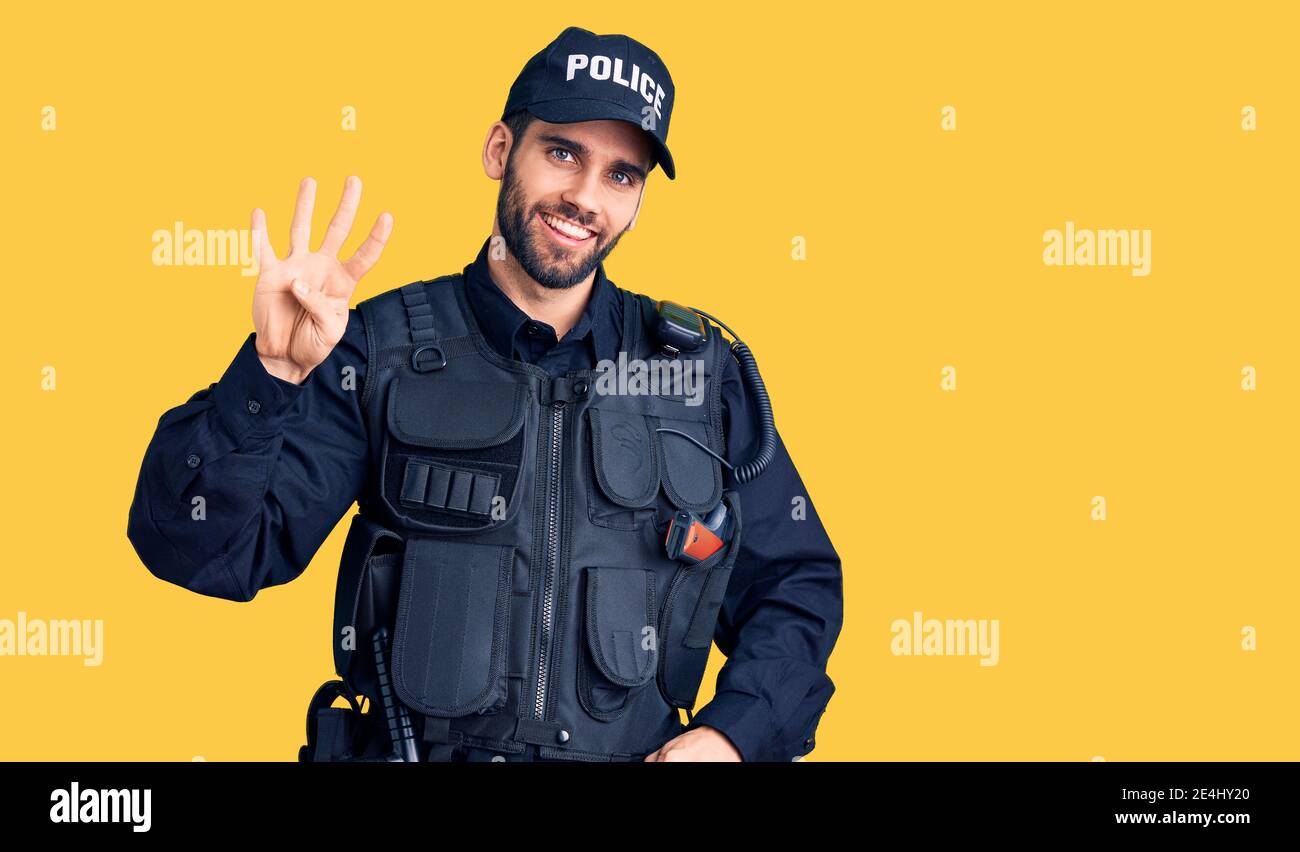 Young handsome man with beard wearing police uniform showing and ...