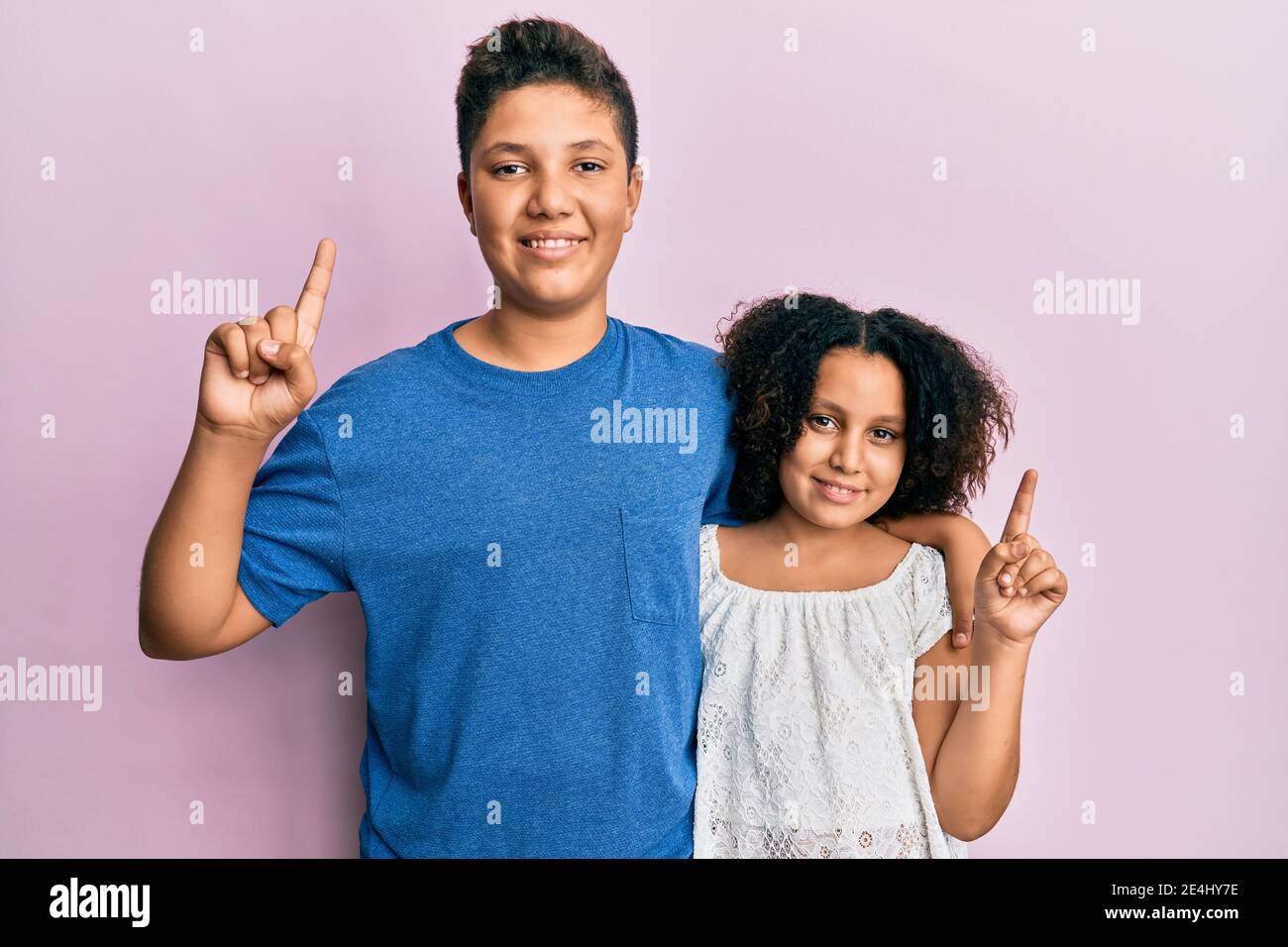 Young hispanic family of brother and sister wearing casual clothes ...
