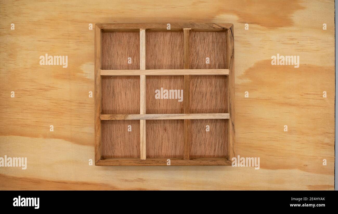 A wooden box with empty compartments, suitable for creating a concept ...