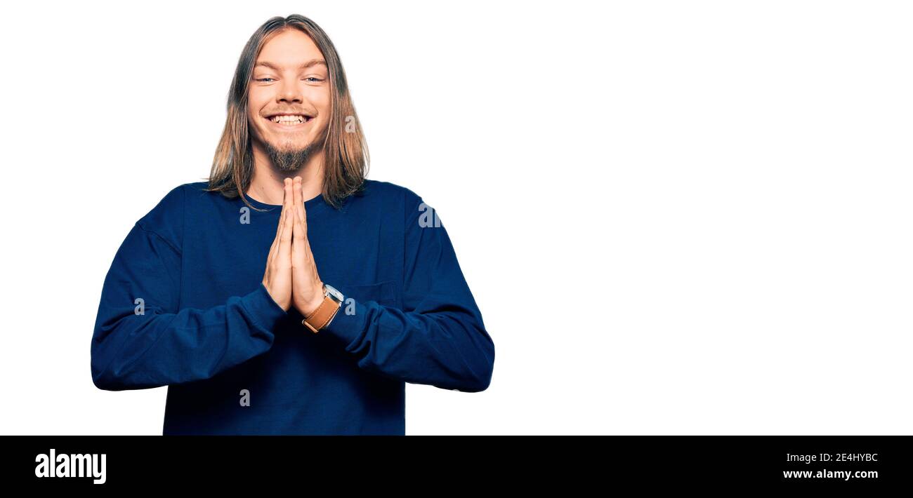 Handsome caucasian man with long hair wearing casual winter sweater ...