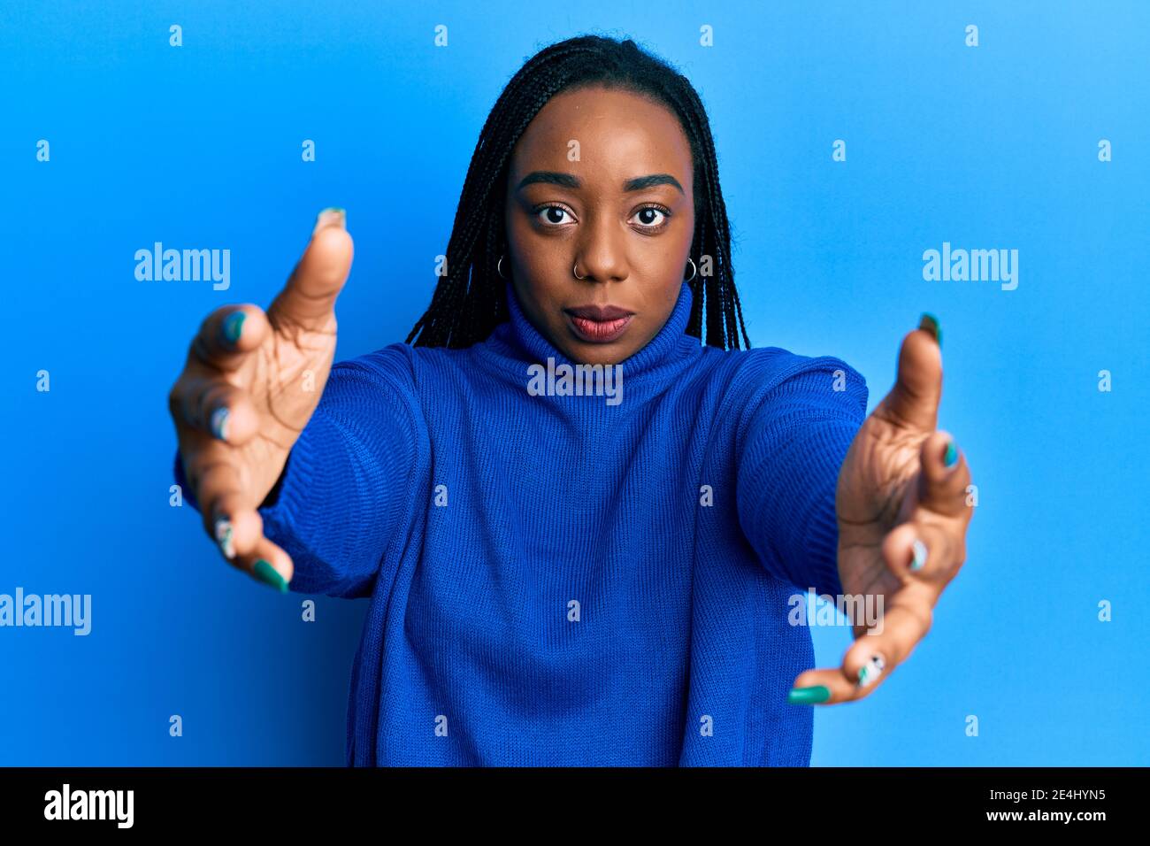 Young african american woman with arms stretched hug gesture relaxed ...