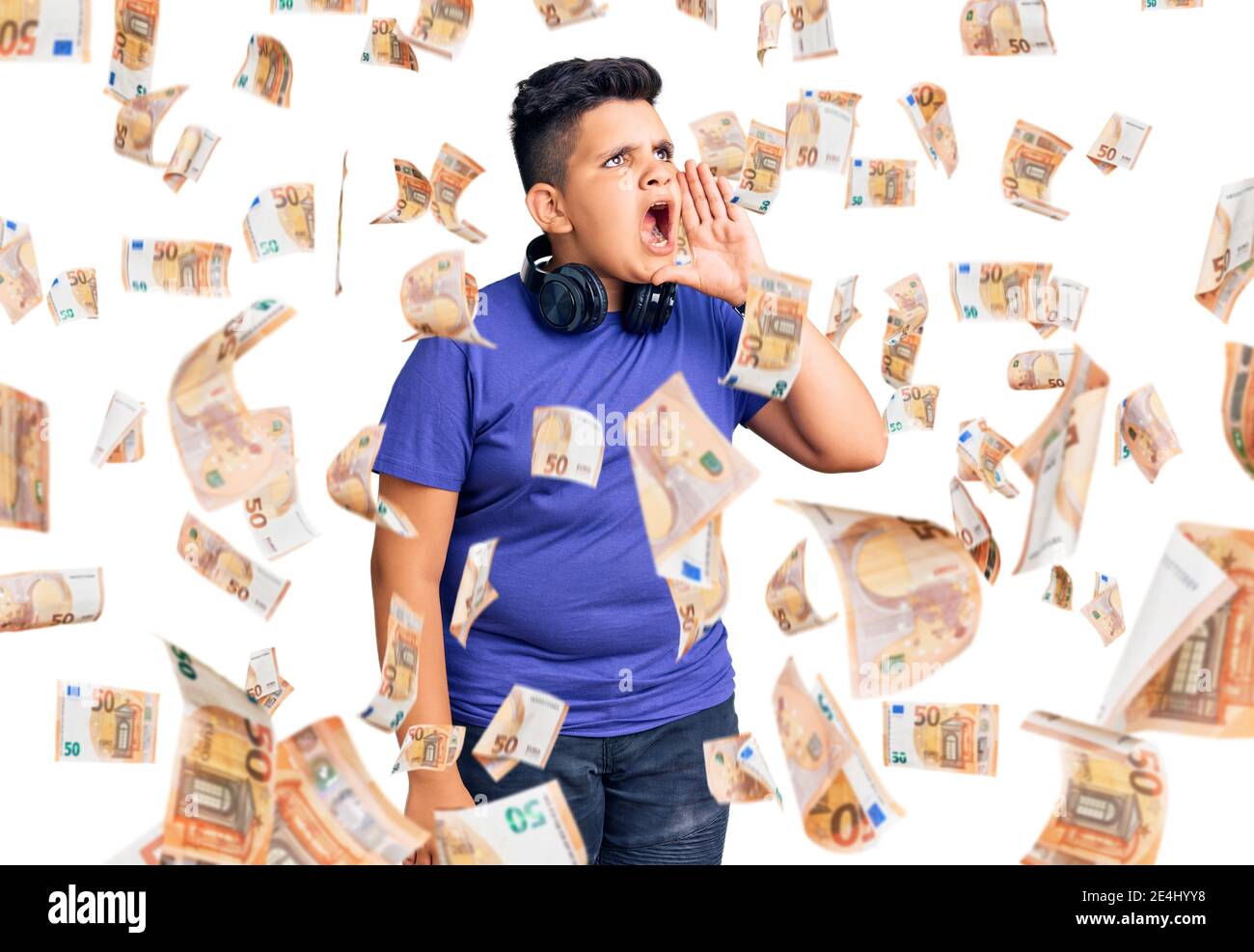 Little boy kid listening to music wearing headphones shouting and ...