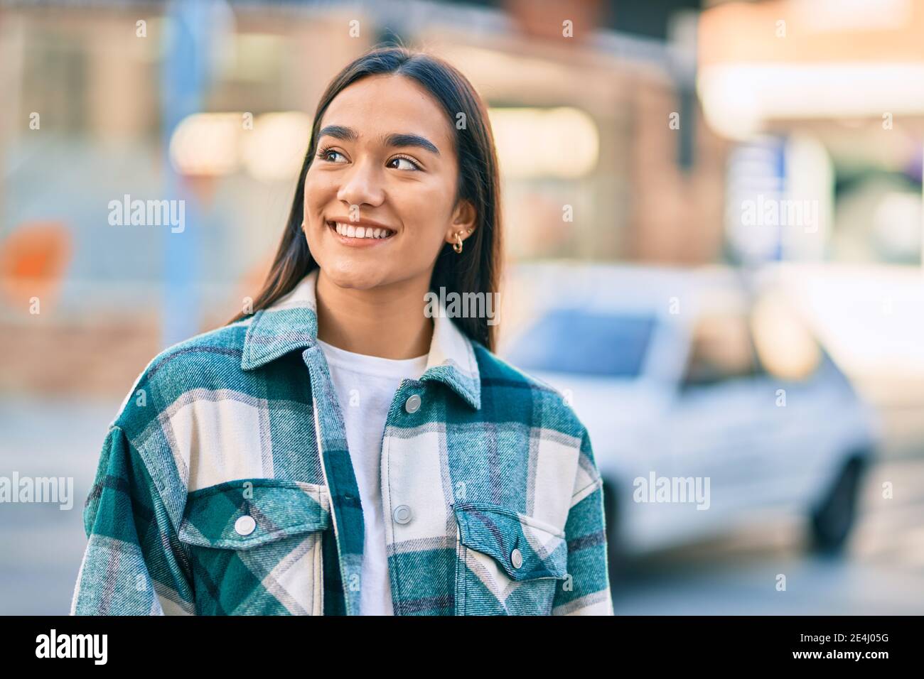 Young latin girl smiling happy standing at the city Stock Photo - Alamy