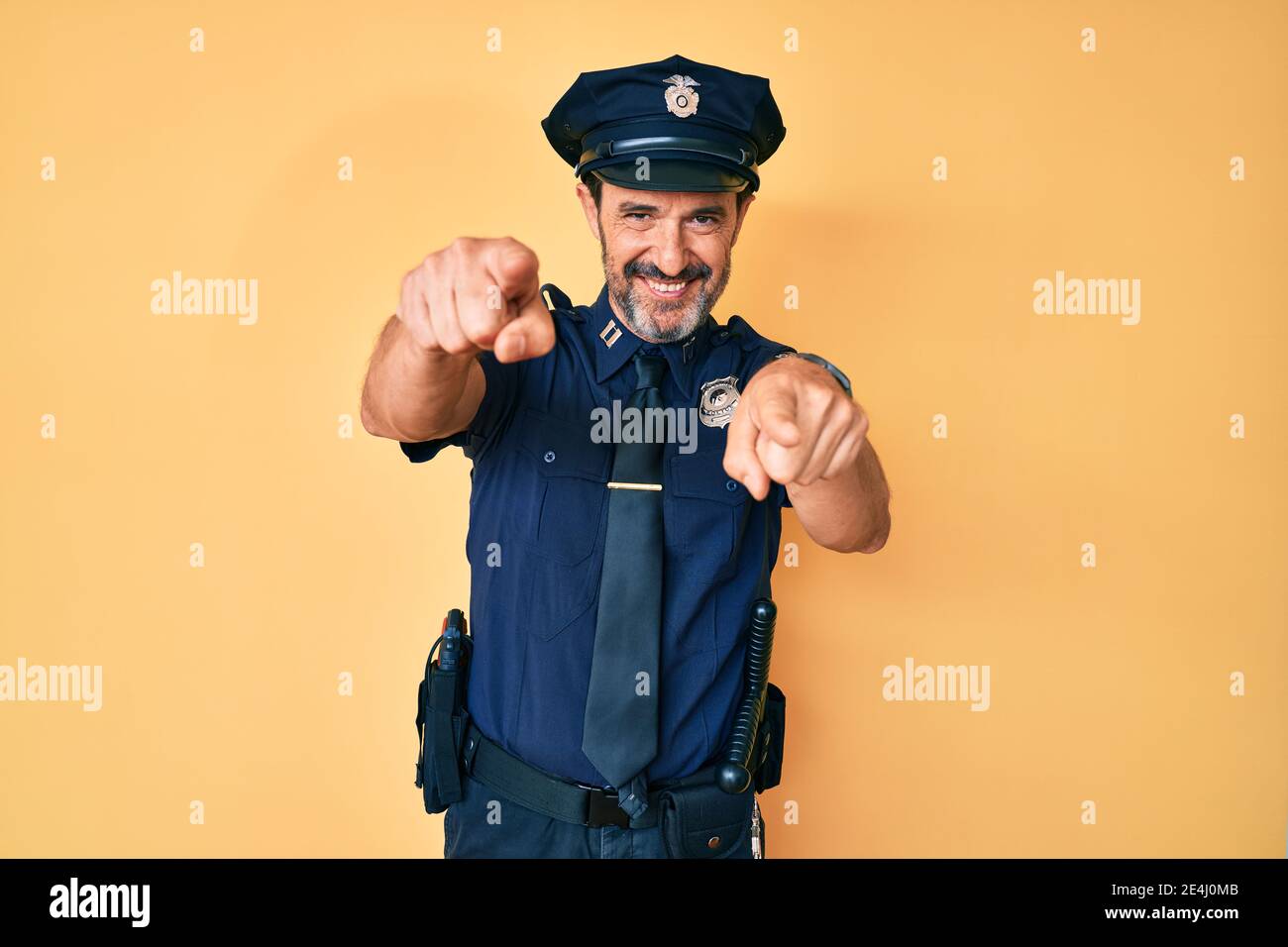 Middle age hispanic man wearing police uniform pointing to you and the ...