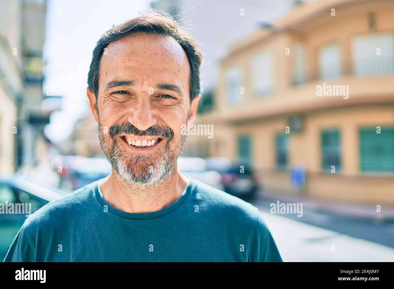 Middle age man with beard smiling happy outdoors Stock Photo - Alamy