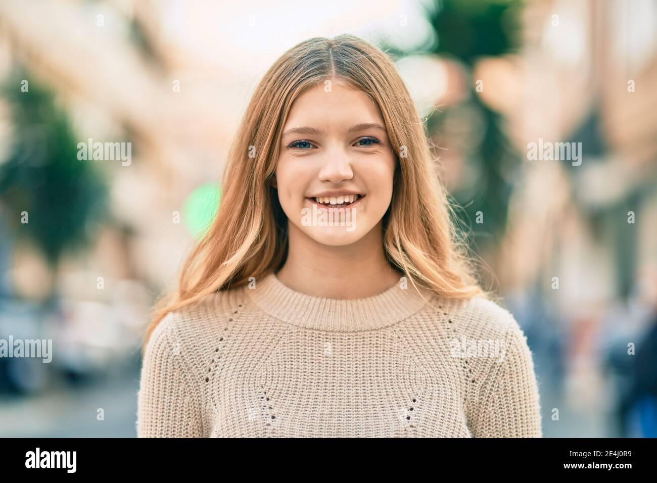Beautiful caucasian teenager smiling happy standing at the city Stock ...