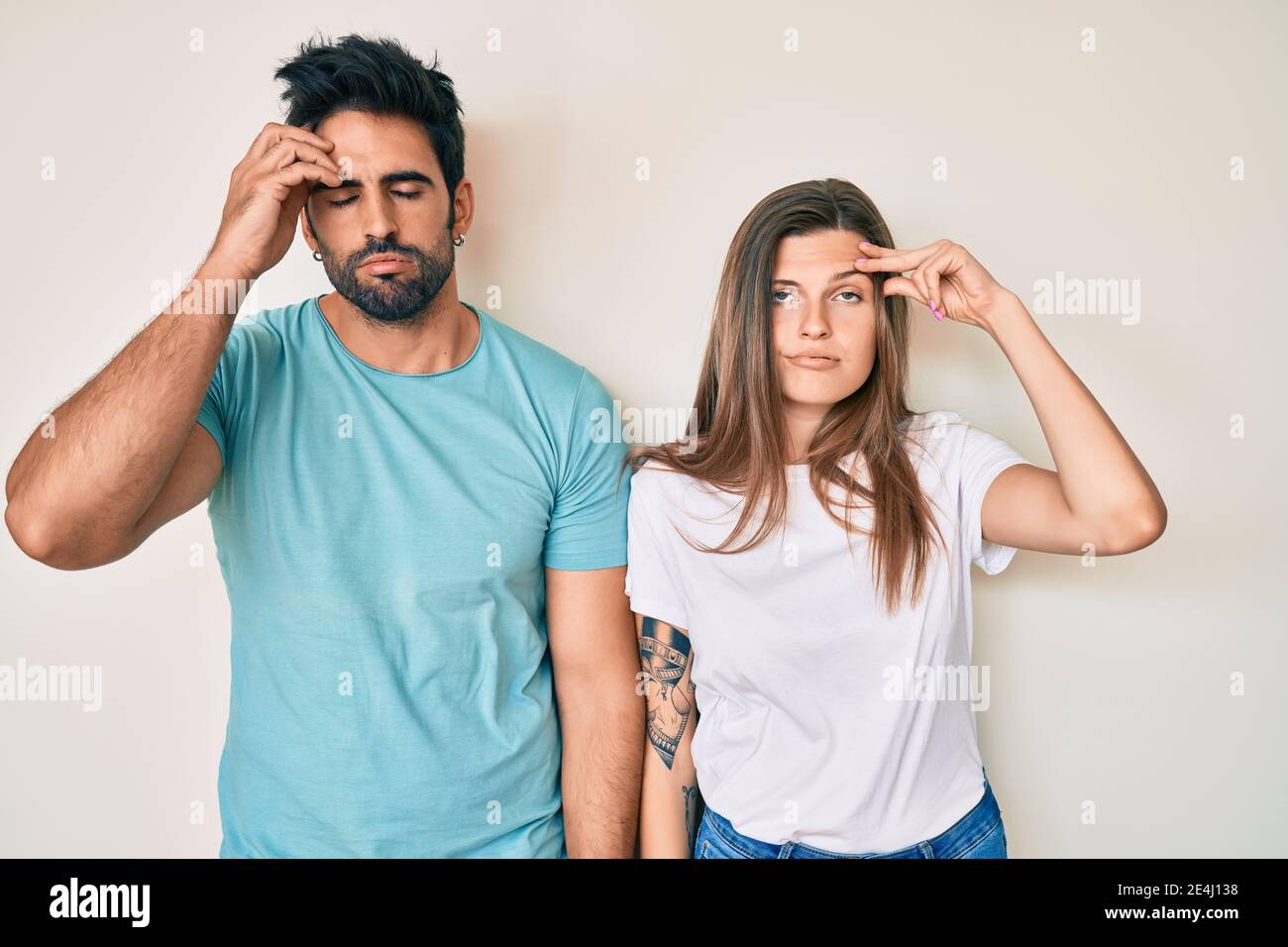 Beautiful young couple of boyfriend and girlfriend together worried and ...