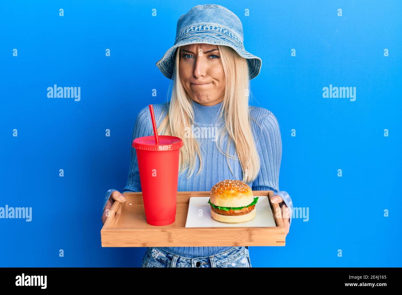 Nervous person eating hamburger hi-res stock photography and images - Alamy