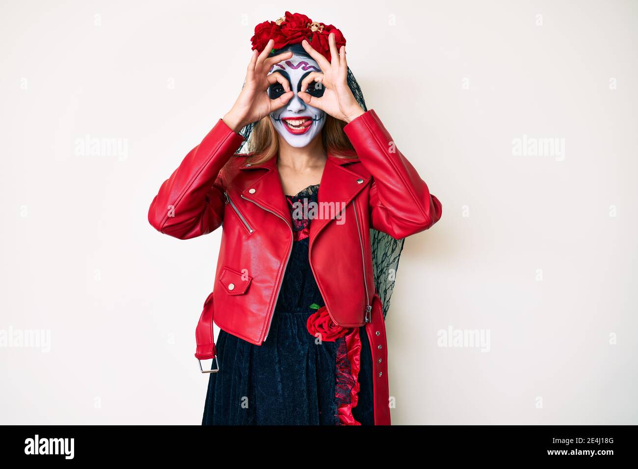 Woman wearing day of the dead costume over white doing ok gesture like ...