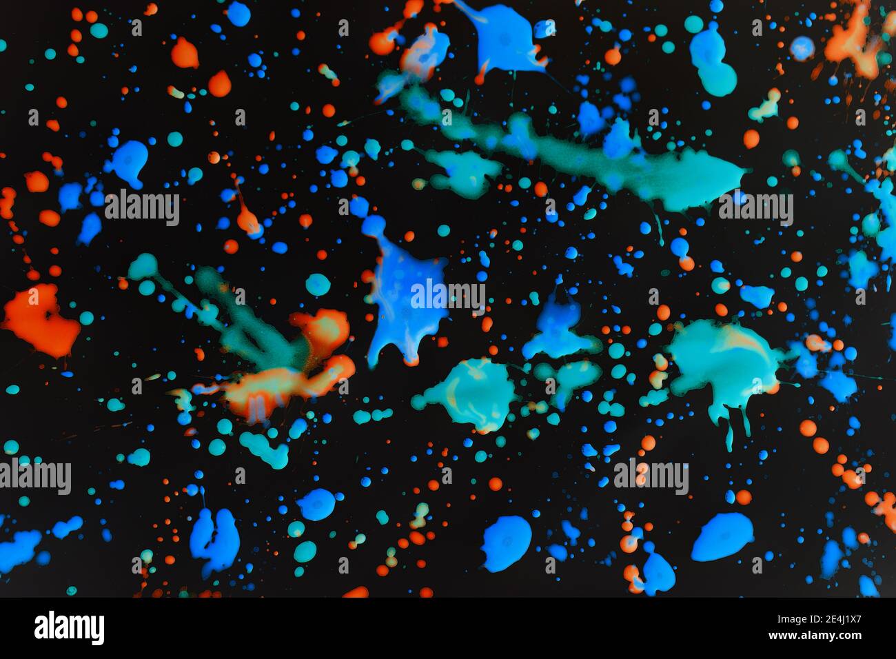 Speckled paint of different colors on a black background Stock Photo ...