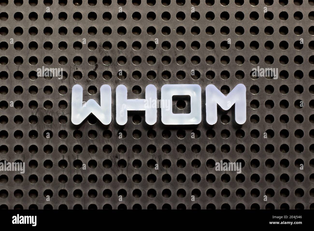 White color letter in word whom on black pegboard background Stock ...