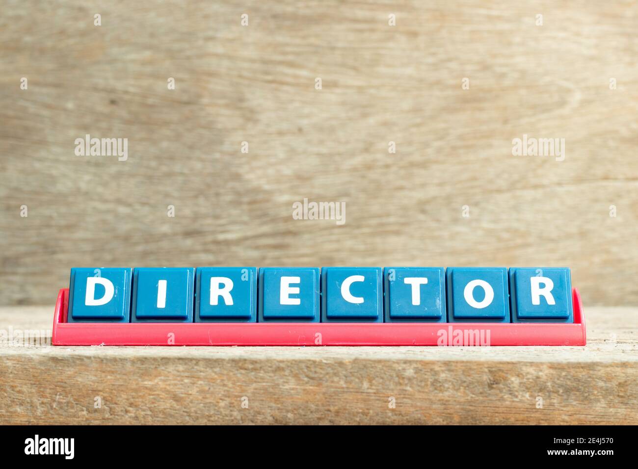 Tile letter on red rack in word director on wood background Stock Photo ...