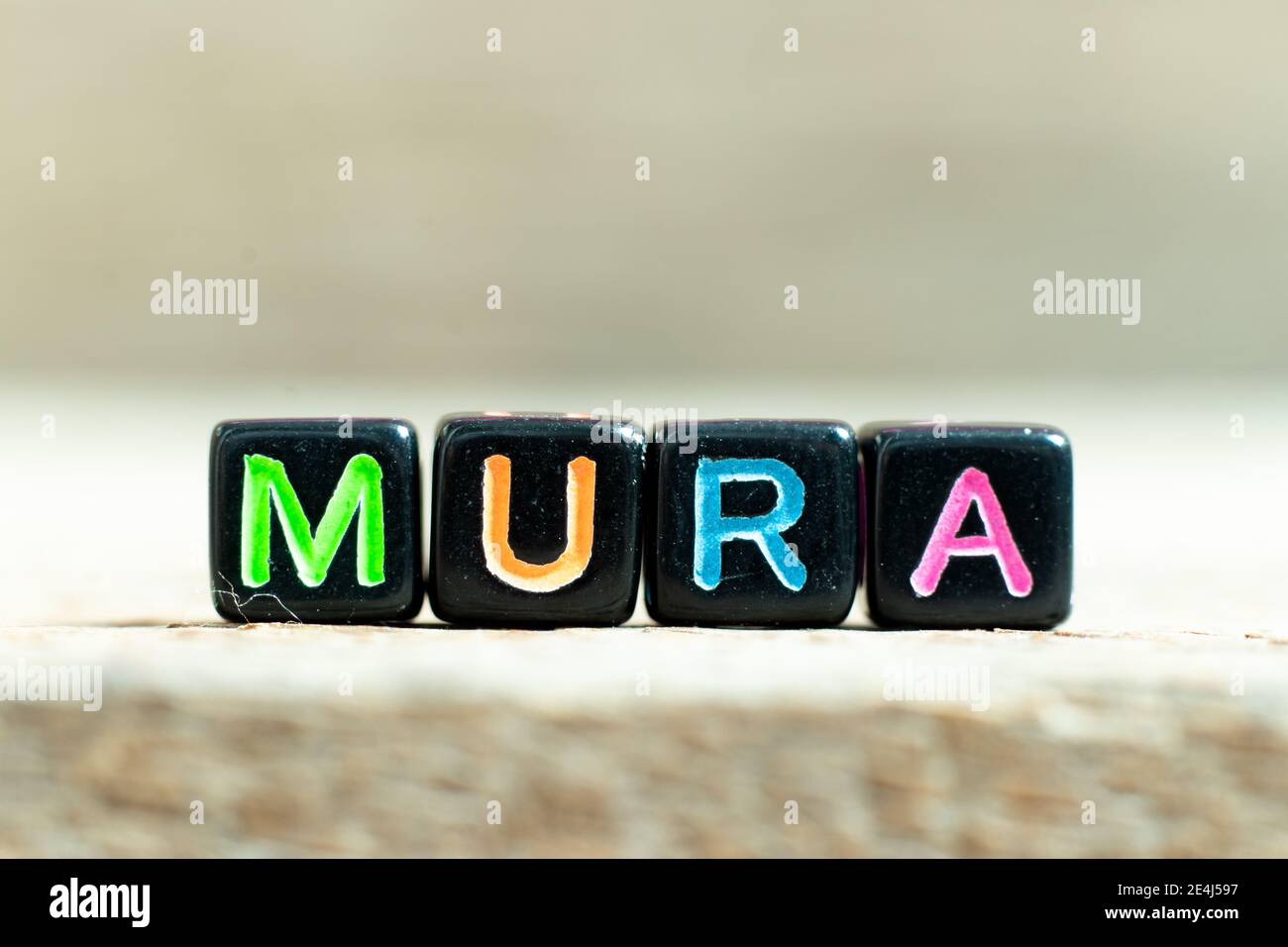 Black color block with word mura on wood background Stock Photo - Alamy