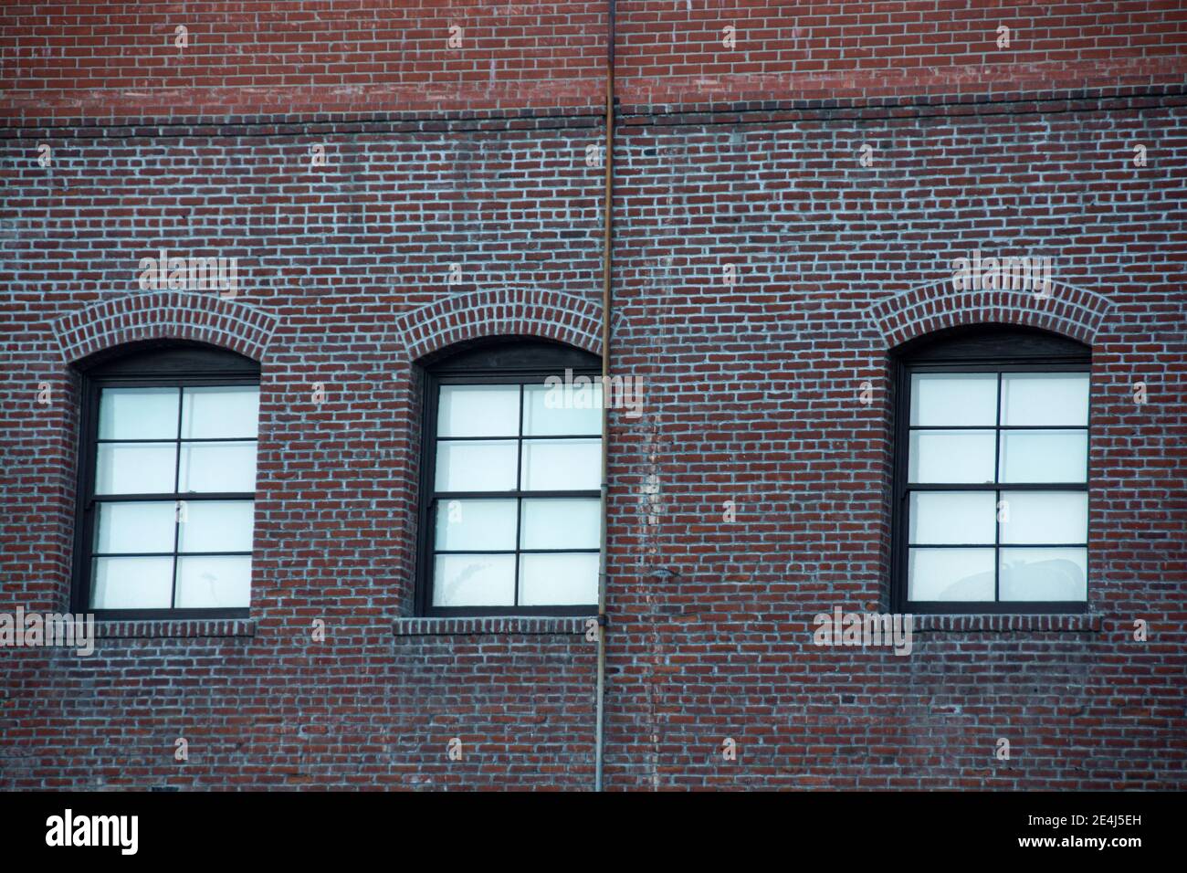 A building made out of brick, showing three windows in the frame Stock ...