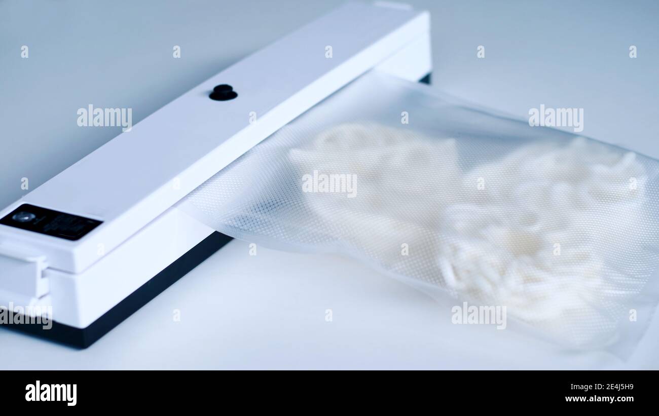 Wrap food using a vacuum sealer machine Stock Photo - Alamy