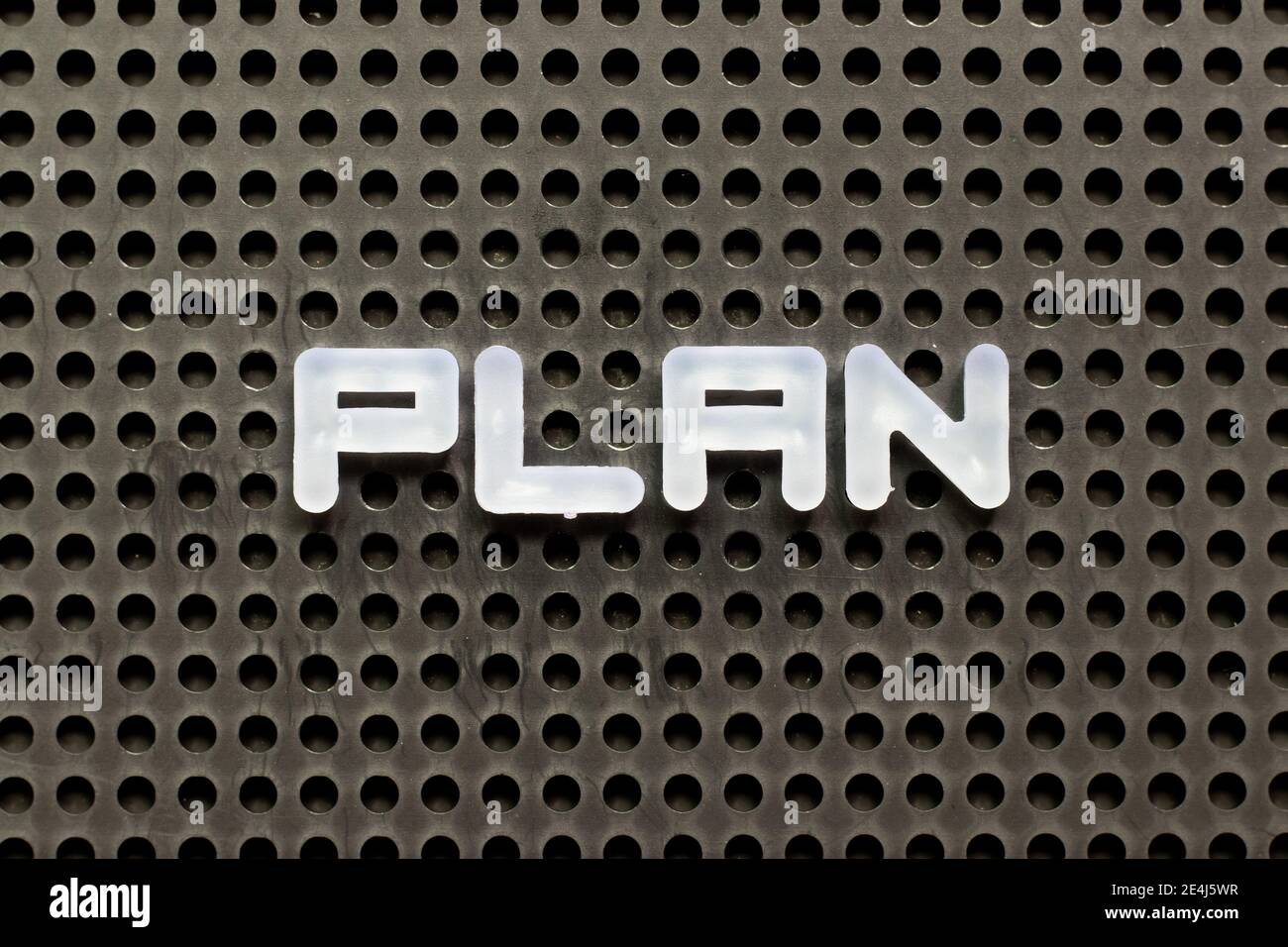 White color letter in word plan on black pegboard background Stock ...