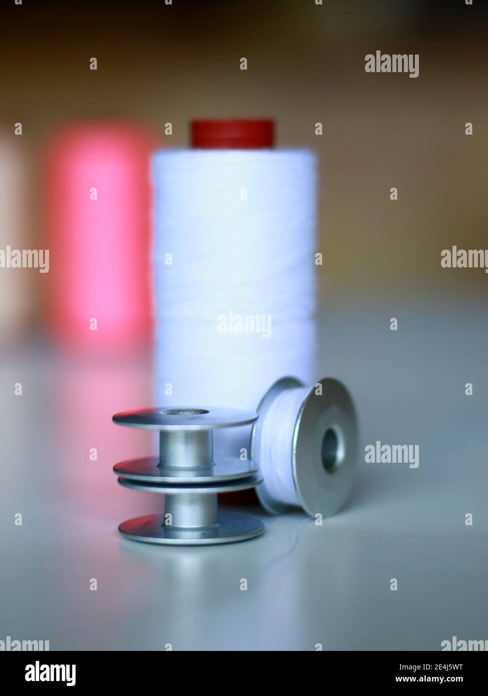 Bobbins on thread background. Tools for sewing Stock Photo - Alamy