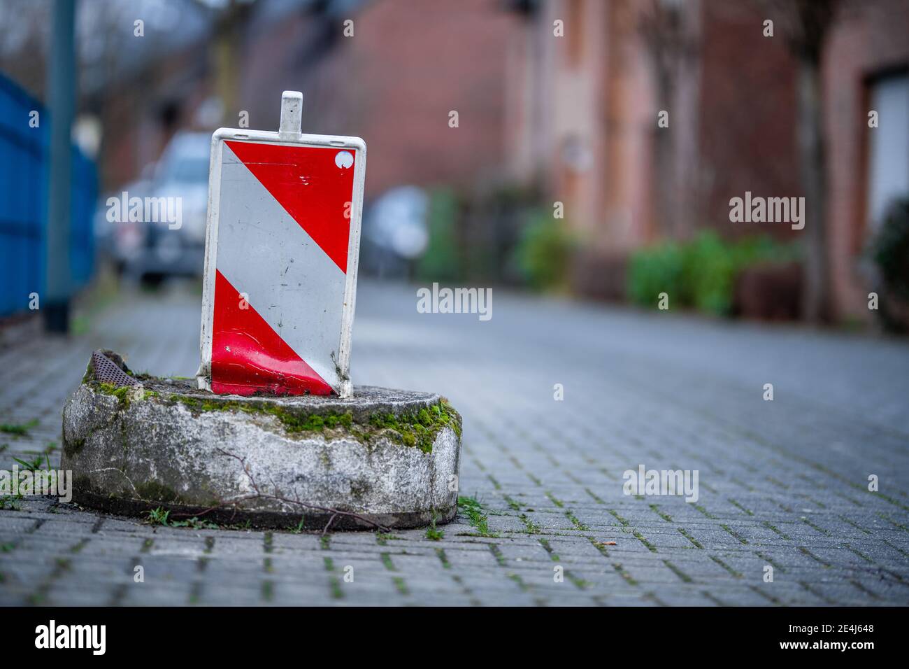 A view of road construction sign with red and white lines on the street ...