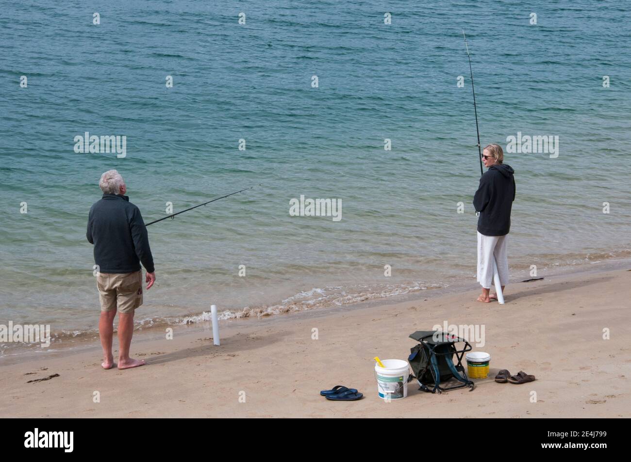 Father and daughter fishing together off the beach at Inverloch on ...