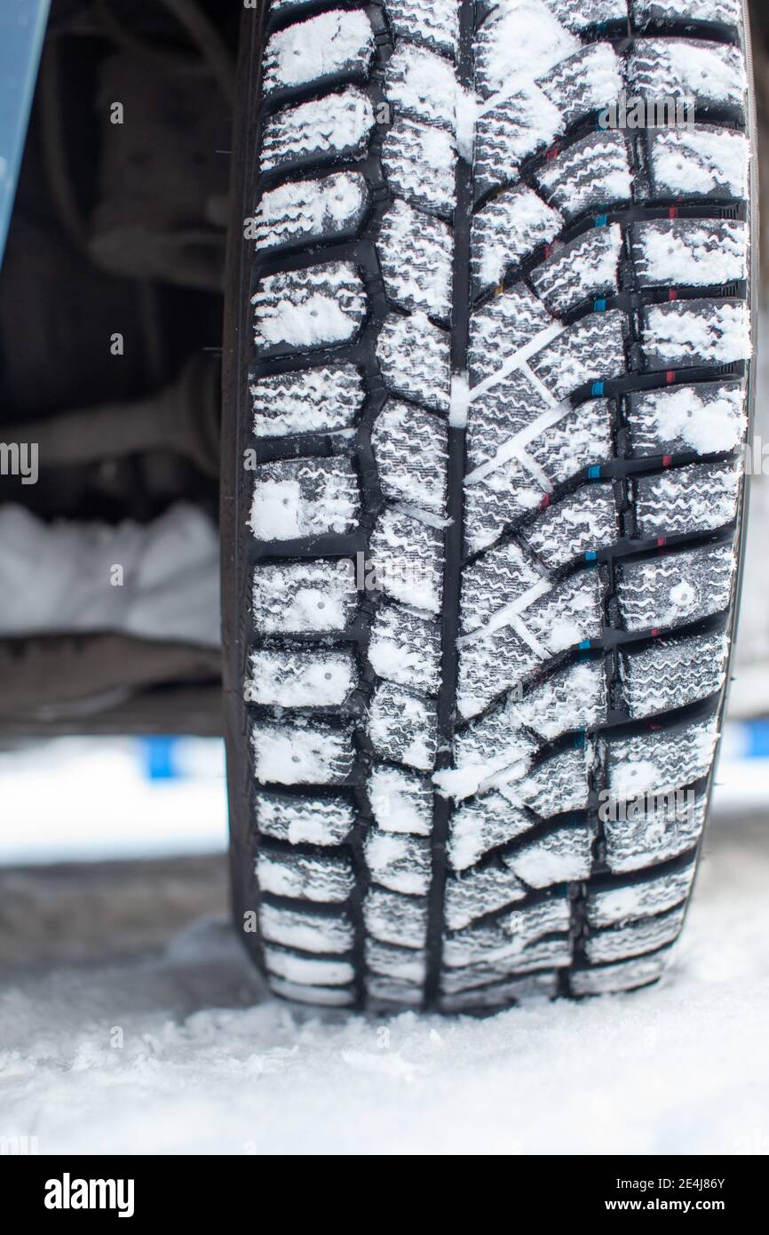 Car tires on the winter road are covered with snow Stock Photo - Alamy