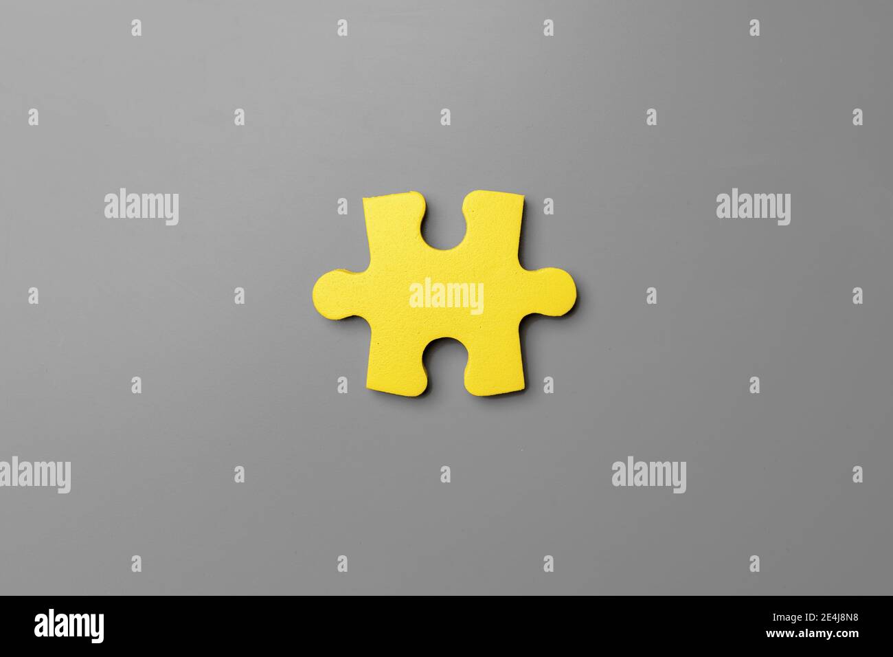 Yellow puzzle pieces on gray background close up Stock Photo - Alamy