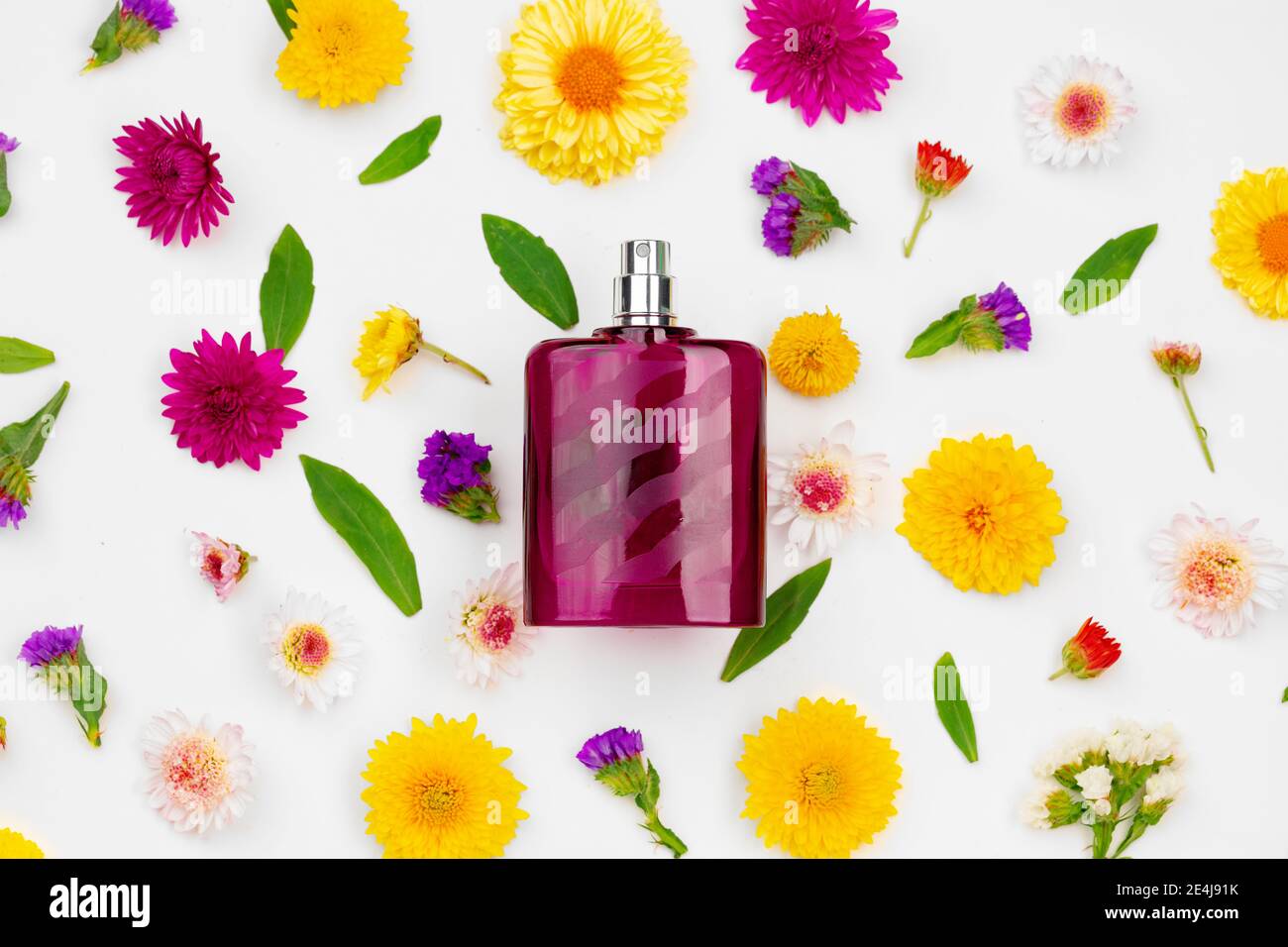 Bottle of fragrance surrounded by flower buds Stock Photo - Alamy