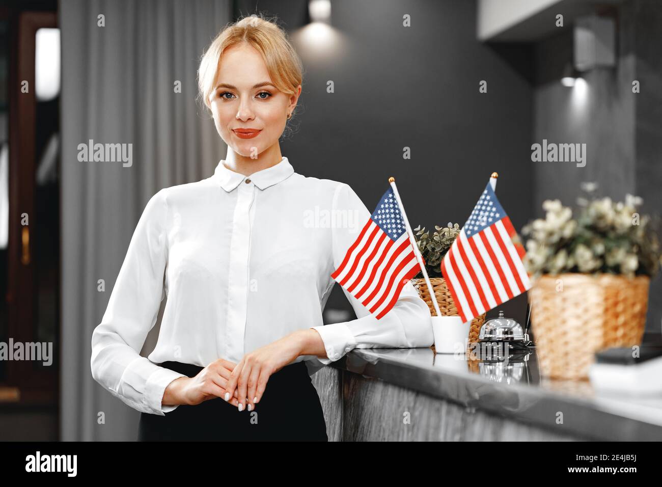Portrait of beautiful blonde woman hotel receptionist Stock Photo - Alamy