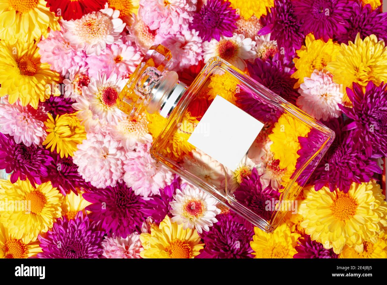 Bottle of fragrance surrounded by flower buds Stock Photo - Alamy