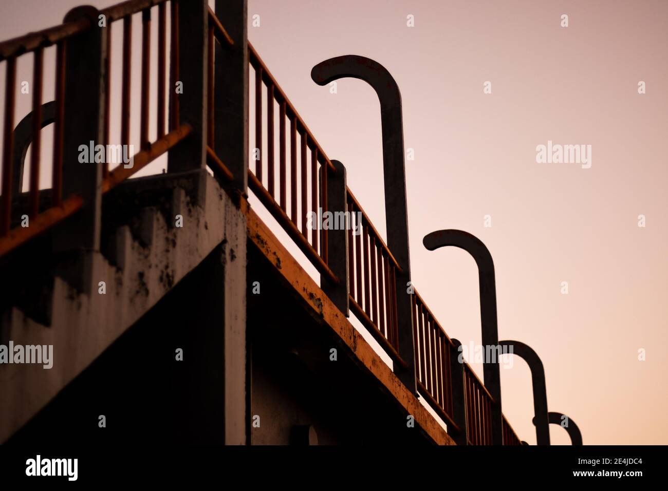 The railings of an old pedestrian bridge against the sunset sk Stock ...
