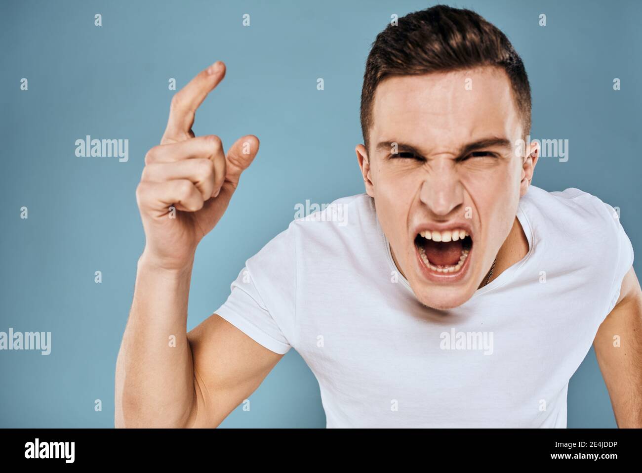 Man gestures with his hands emotions white t-shirt expression blue ...