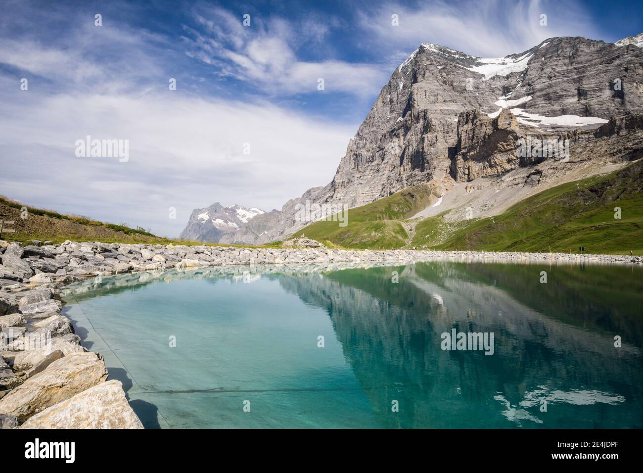 The Eiger reflected in Fallbodensee lake near Eigergletscher station in ...