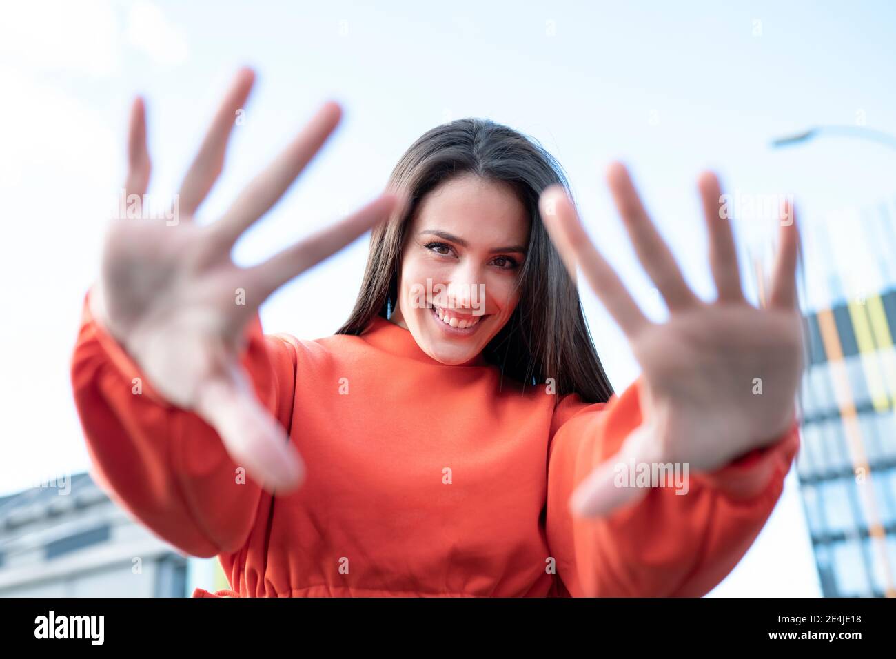 Portrait of beautiful brunette reaching toward camera Stock Photo - Alamy