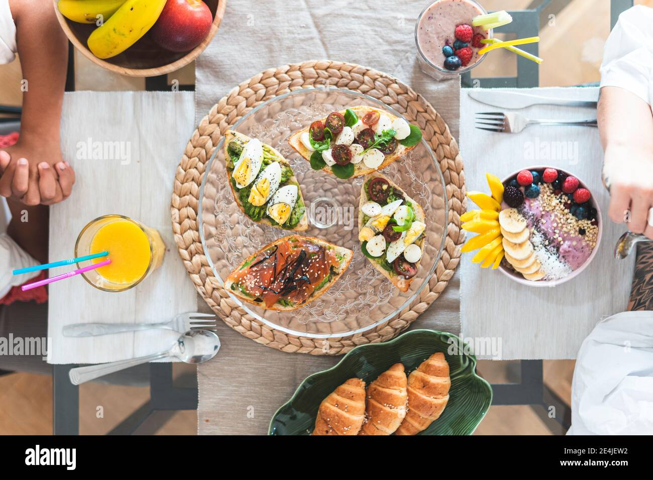 Hands of two people eating healthy breakfast Stock Photo - Alamy