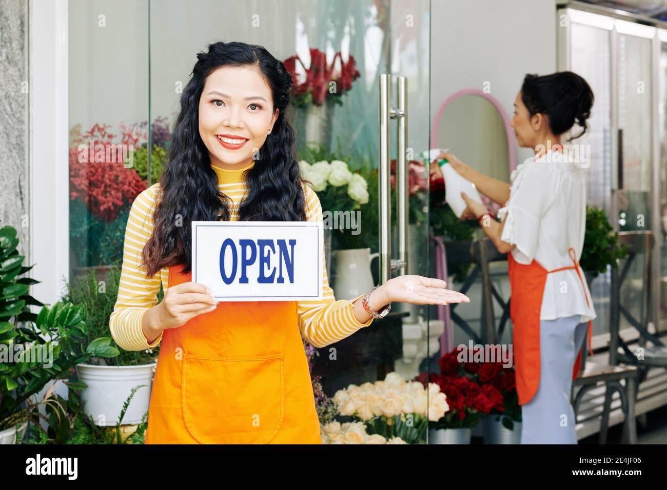 Florist holding open sign Stock Photo - Alamy