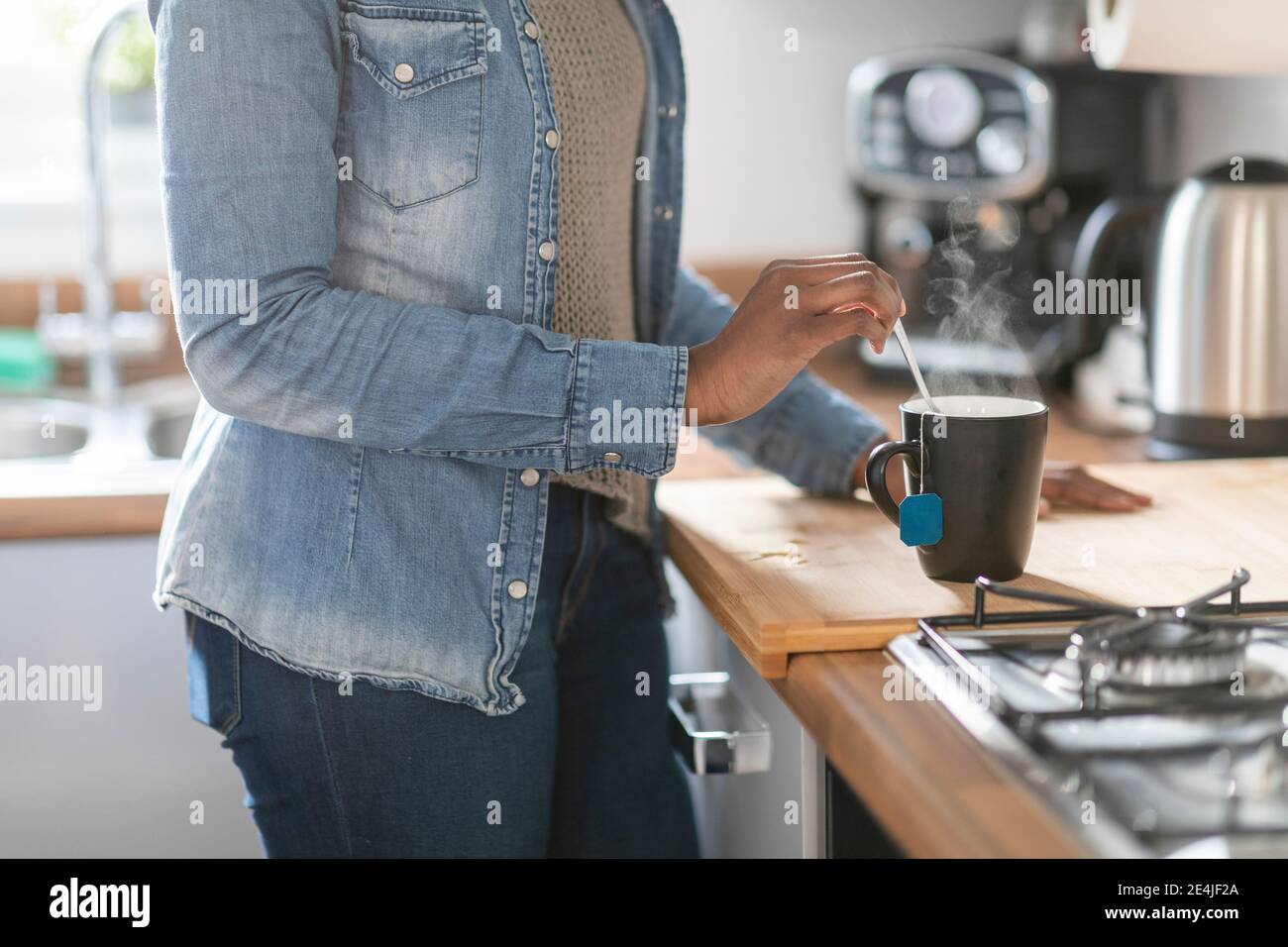 Woman preparing tea hi-res stock photography and images - Alamy