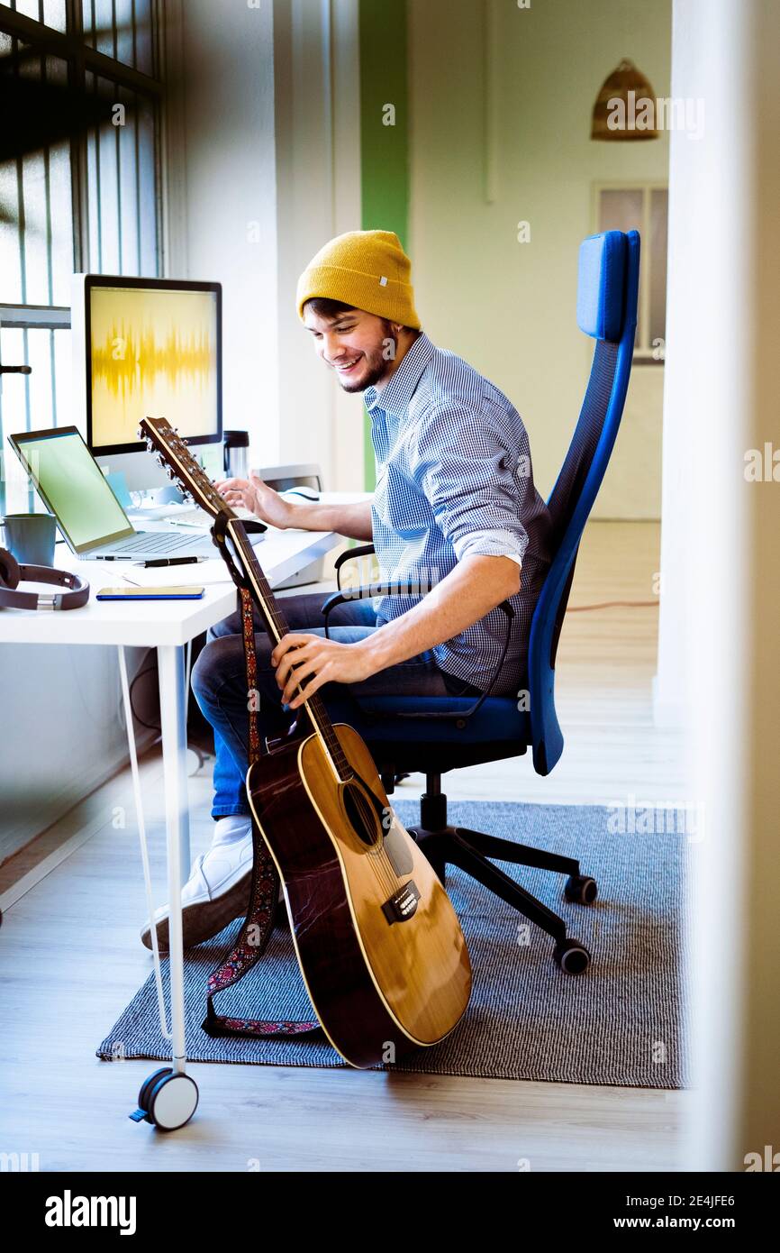 Smiling musician taking guitar hi-res stock photography and images - Alamy