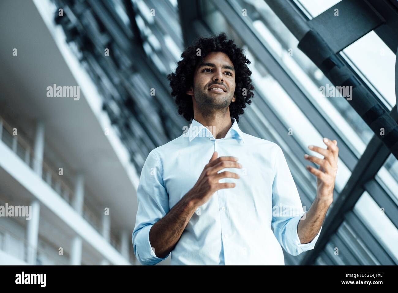 Standing looking away communication gesturing hi-res stock photography ...
