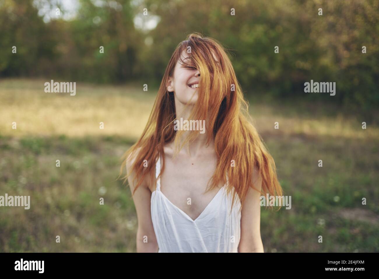happy journey in a white sundress running on the grass in nature Stock ...