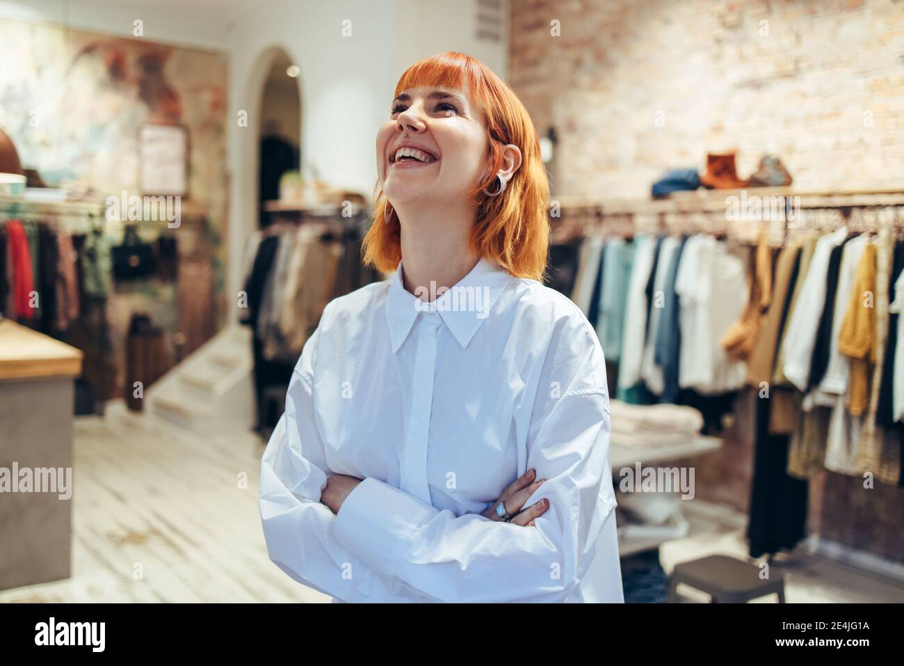 Successful woman standing in her store. Happy female entrepreneur in ...