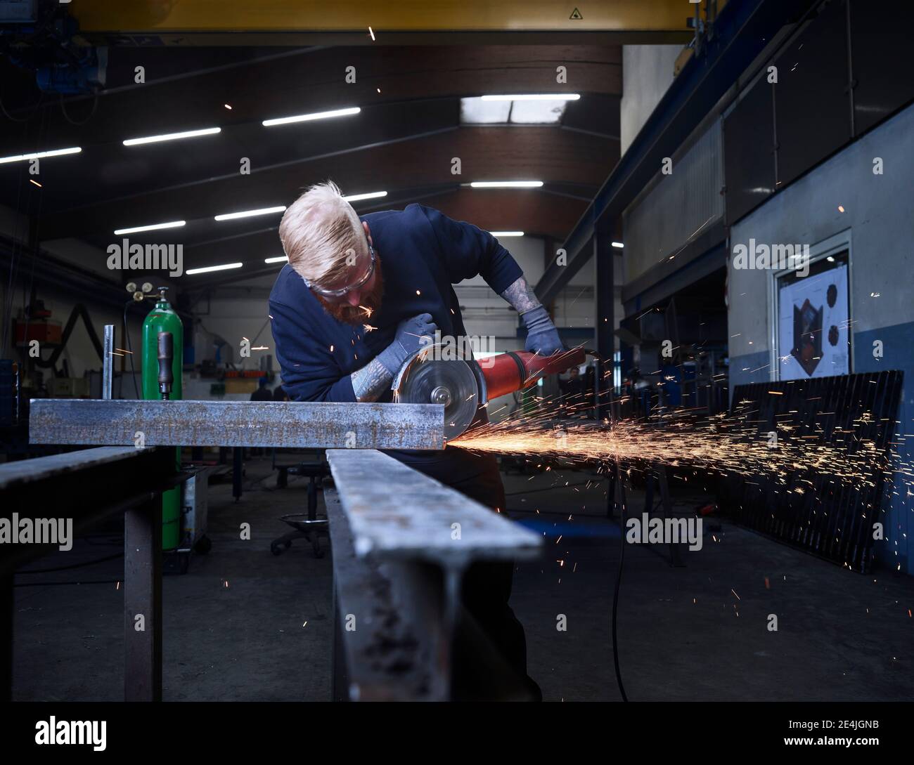 Manual worker using cutting material using circular grinder while ...