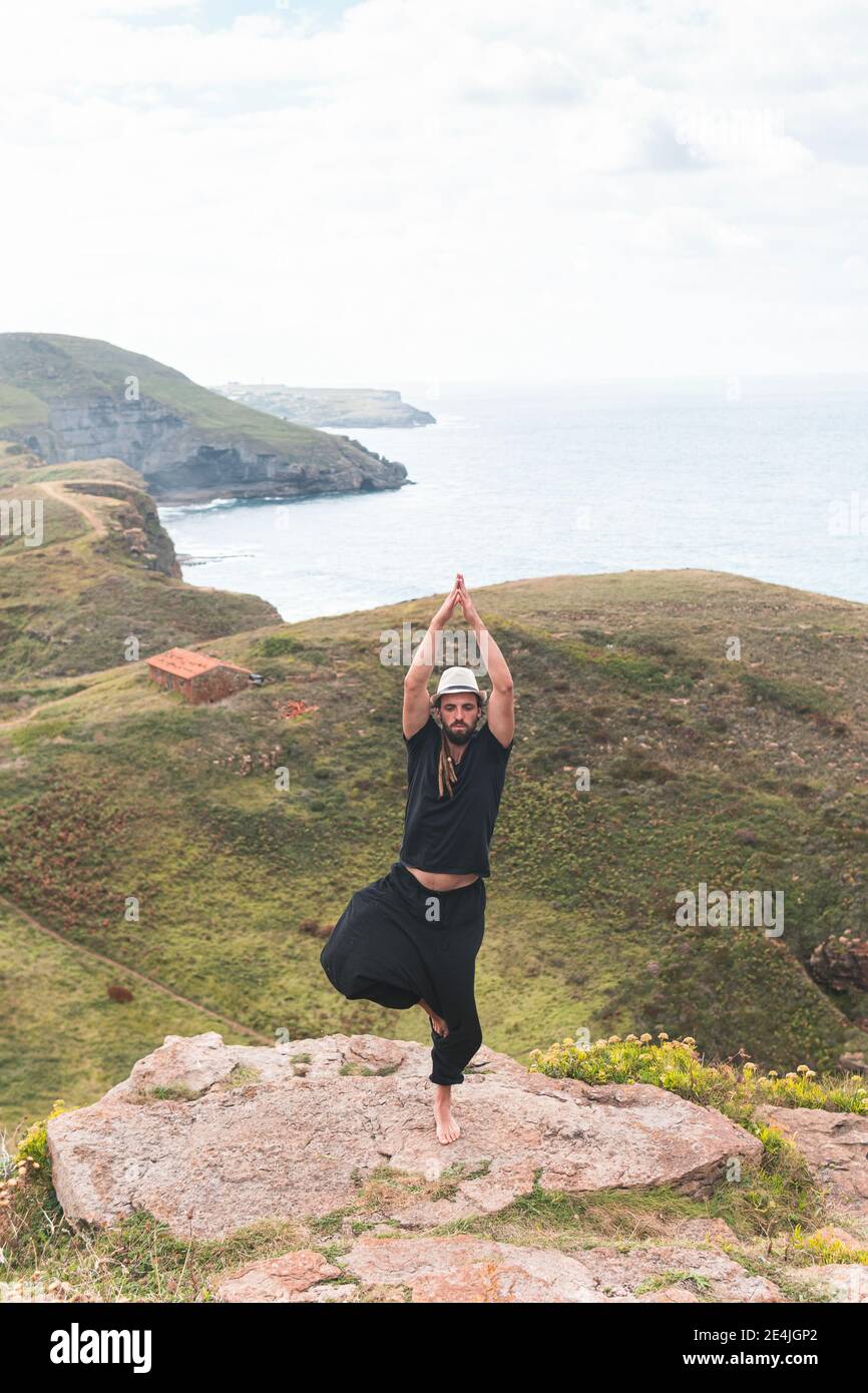 Young man standing one leg hands clasped mounta santander hi-res stock ...