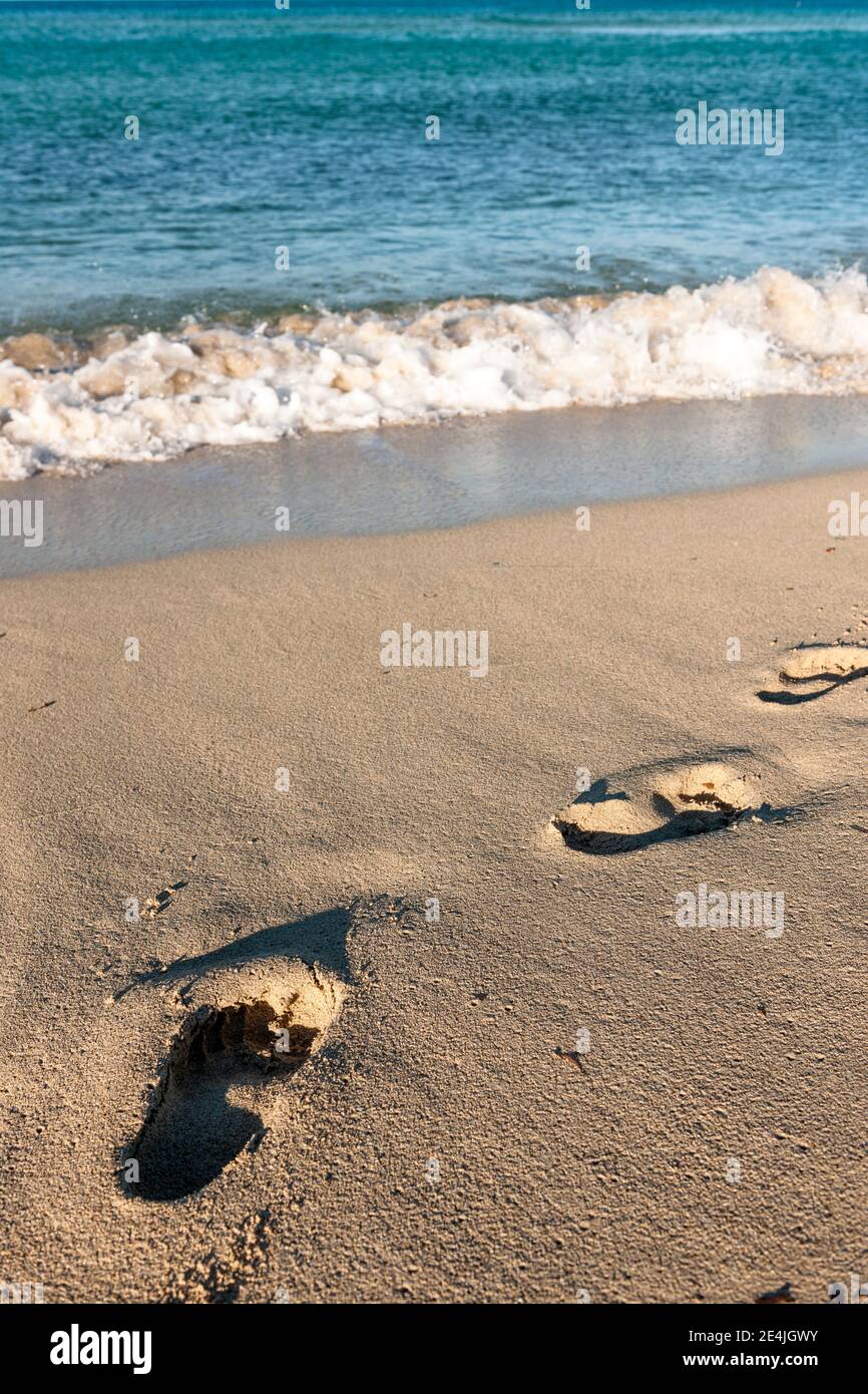 Footprints in beach sand Stock Photo - Alamy
